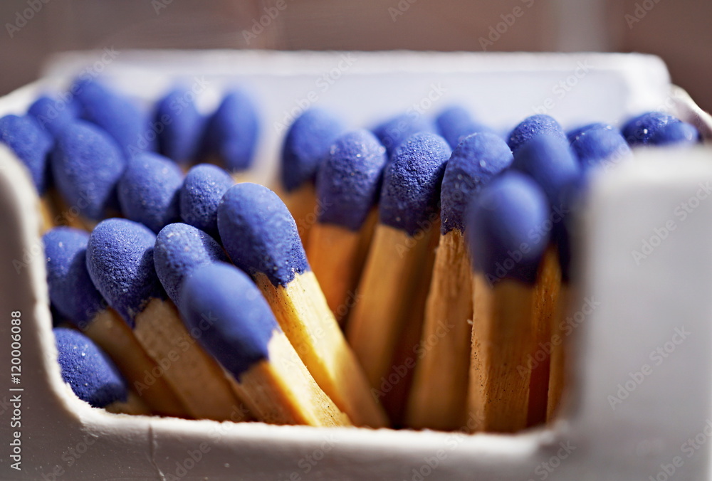 Macro detail of safety match sticks with blue heads in the paper match ...
