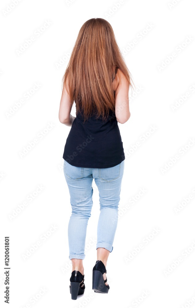 back view of running woman. beautiful red head girl in motion. backside ...
