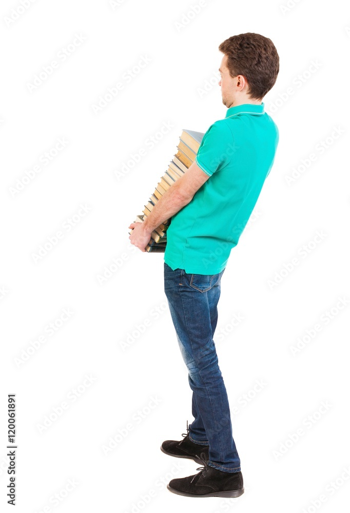 A man carries a heavy pile of books. back view. Rear view people ...