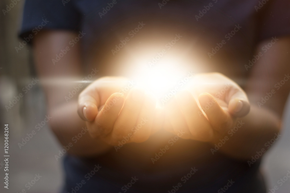 Holding hands open with glowing lights on dark background Stock Photo ...