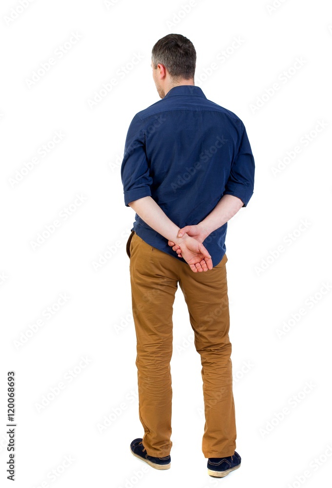 Back view of man . Standing young guy. man in a blue shirt with the ...