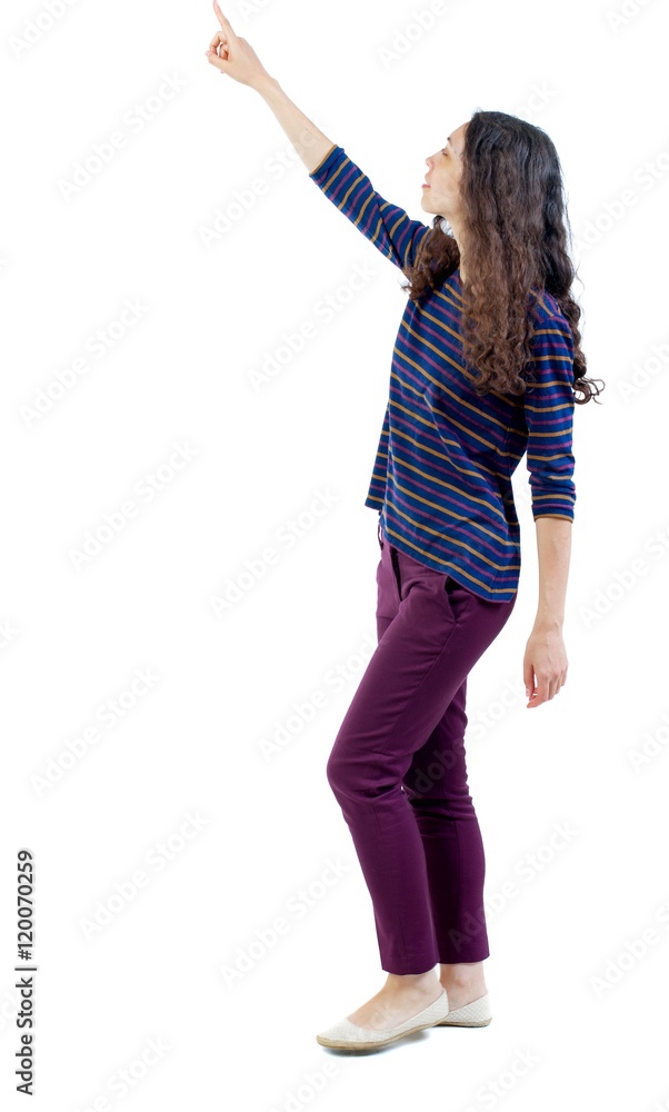 back view of walking woman. beautiful redhead girl pointing. backside ...