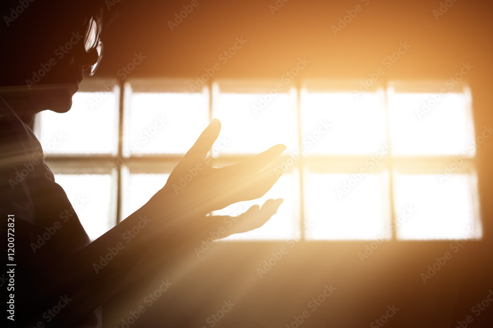 Respect and pray in the room with sunrise through window background ...