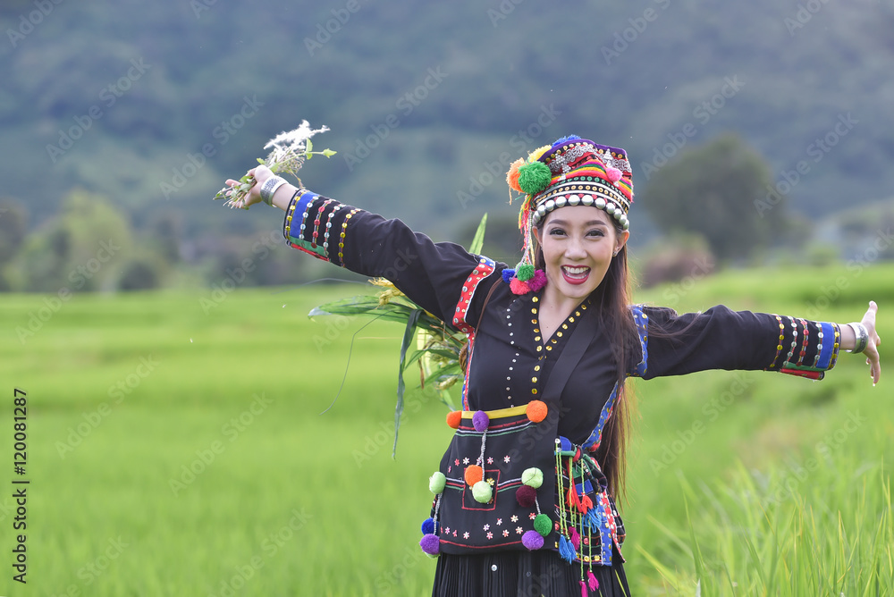 women wearing tribal costumes work in the fields of rice terraces ...