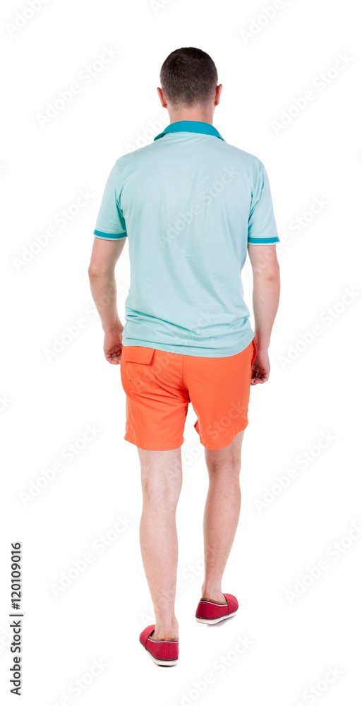 Back view of going handsome man in shorts. walking young guy . Rear ...