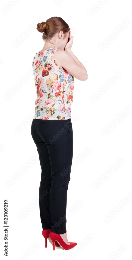Back view of shocked woman in trousers. girl hid his eyes behind his ...