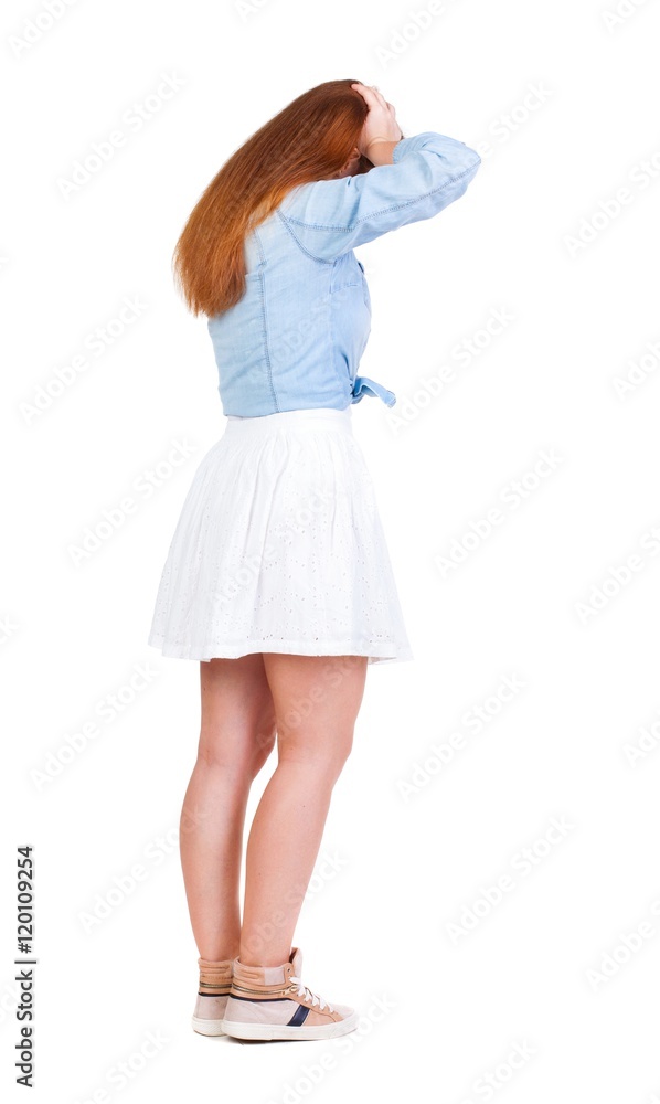 Back view of shocked woman in dress. girl hid his eyes behind his hands ...