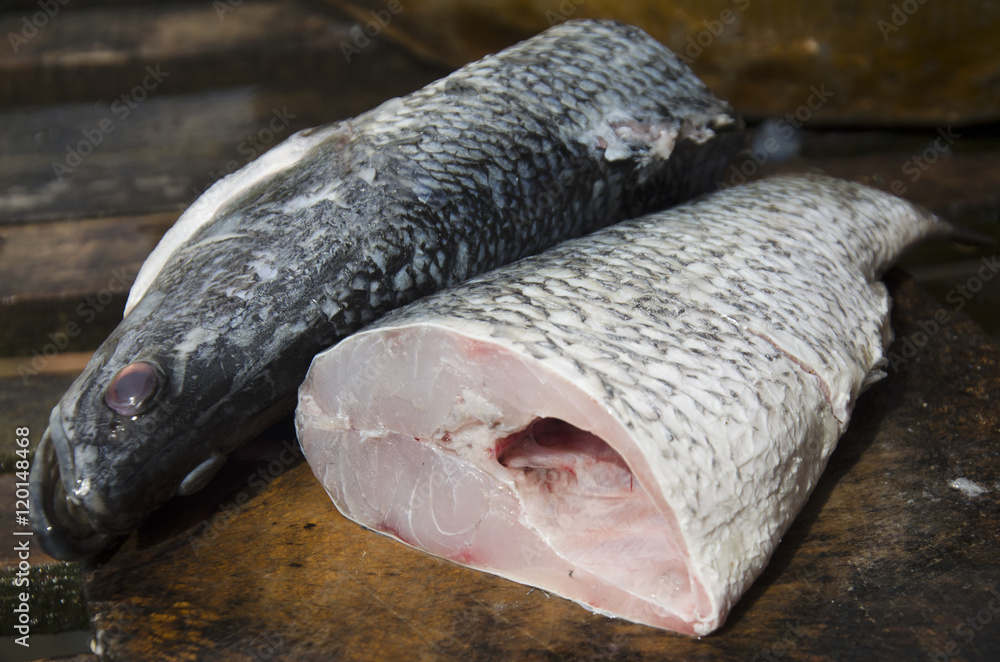 prepare and scale and clean fish Barramundi fish for cooking Stock ...