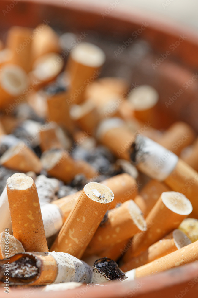 Big pile of put out cigarettes in an ashtray Stock Photo | Adobe Stock