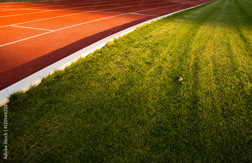 Grass with running track and sunset. Stock Photo | Adobe Stock