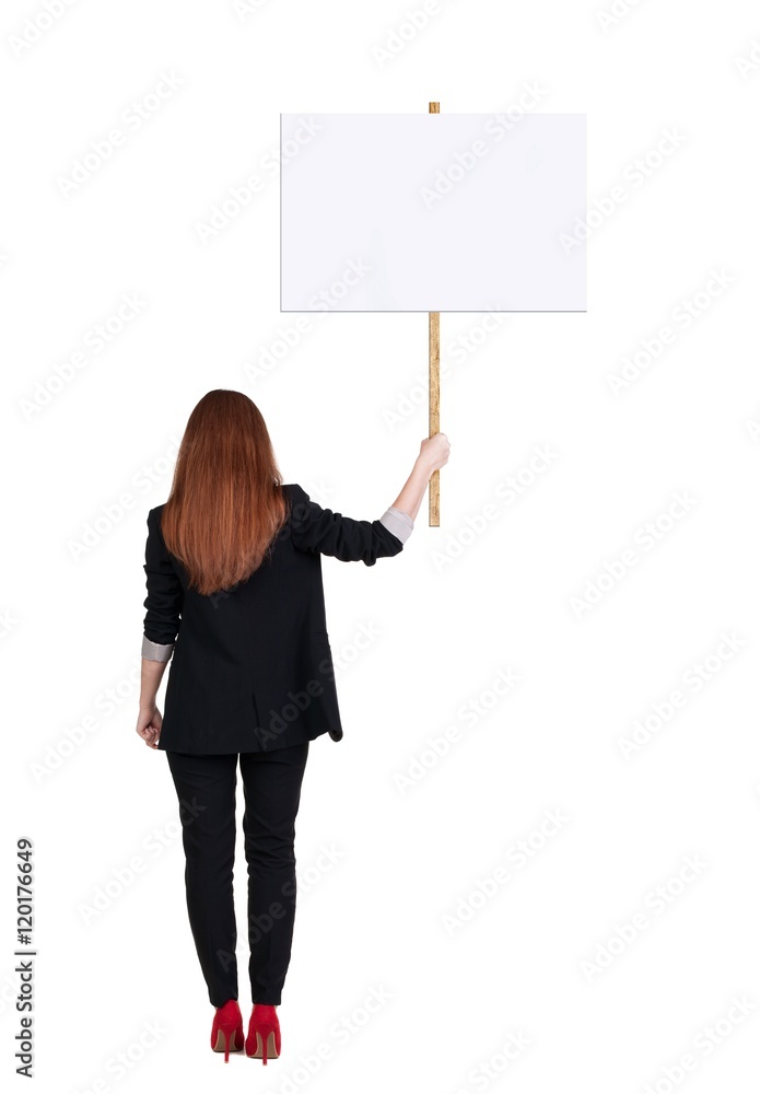 Back view business woman showing sign board. young redhead girl holds ...