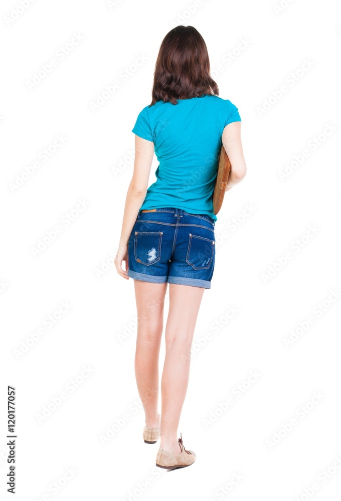 back view of walking woman in shorts. beautiful brunette girl in motion ...