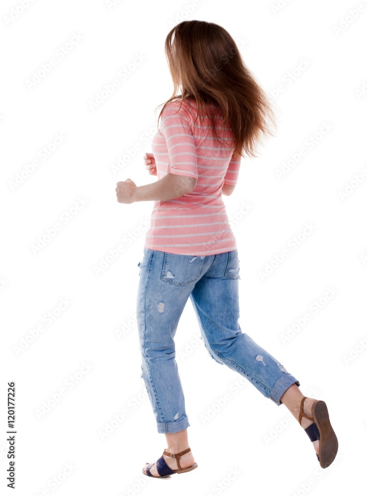 back view of running woman. beautiful redhead girl in motion. backside ...