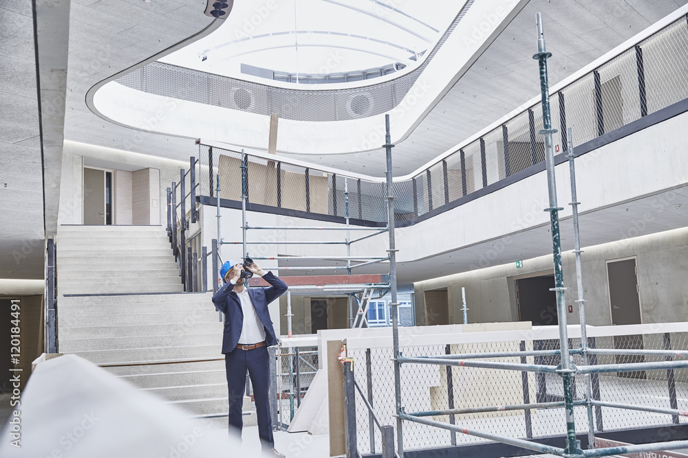 Architect on construction site of office building Stock Photo | Adobe Stock