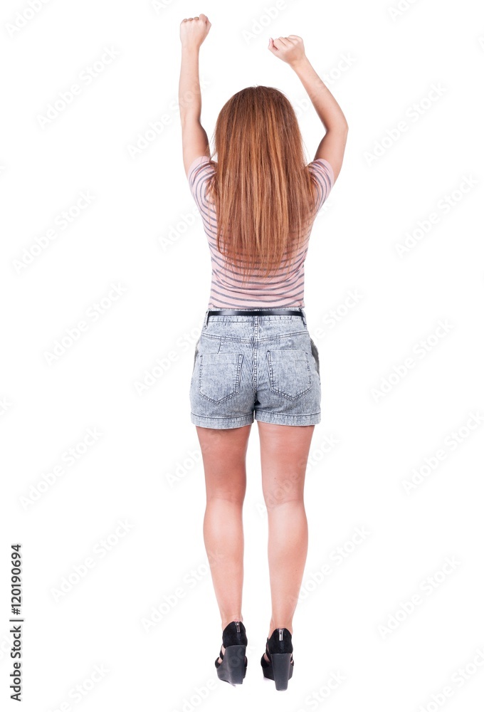back view of standing young beautiful redhead woman thumbs up. girl ...