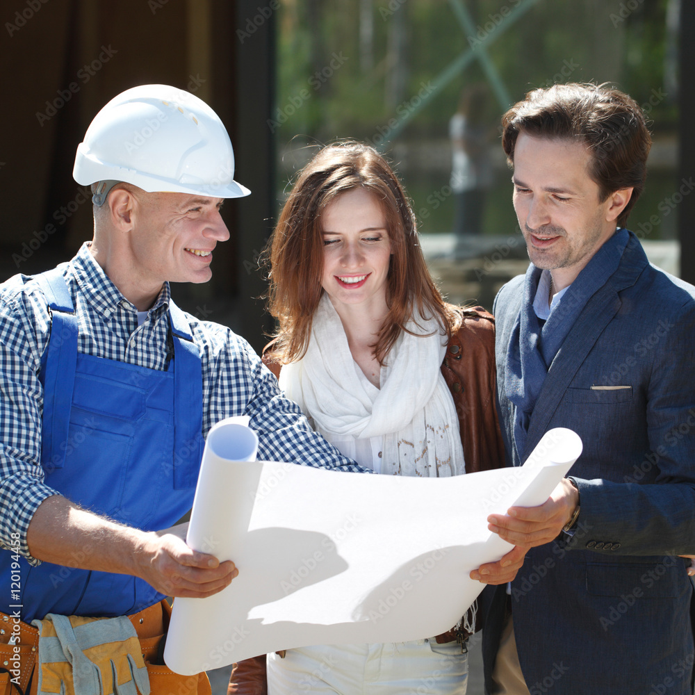 Worker shows house design plans Stock Photo | Adobe Stock