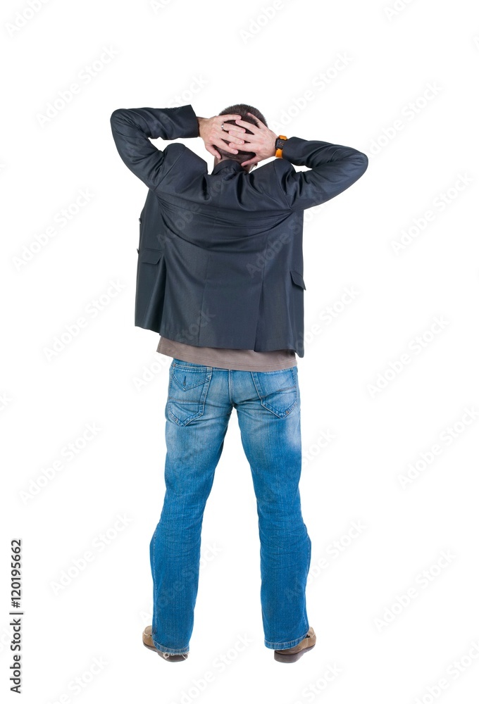 Back view of shocked and scared young business man. Holds hands upwards ...