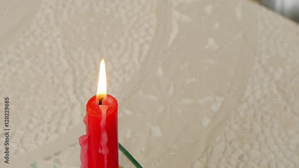 red candle burning on a white background Stock Video | Adobe Stock