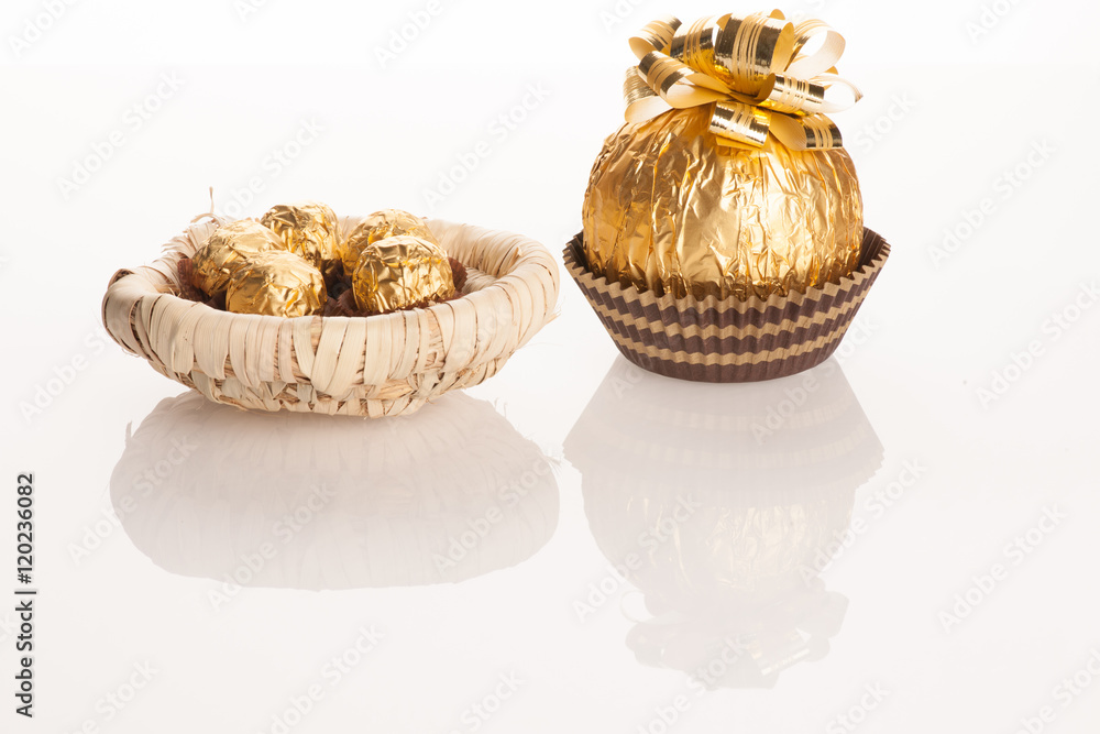 Big round chocolate candy wrapped in golden foil with big bow on Stock ...