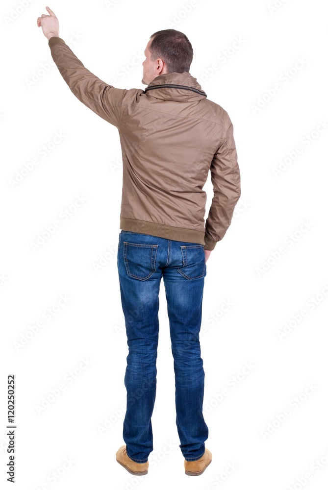Back view of pointing young men in wind breaker. Young guy gesture ...