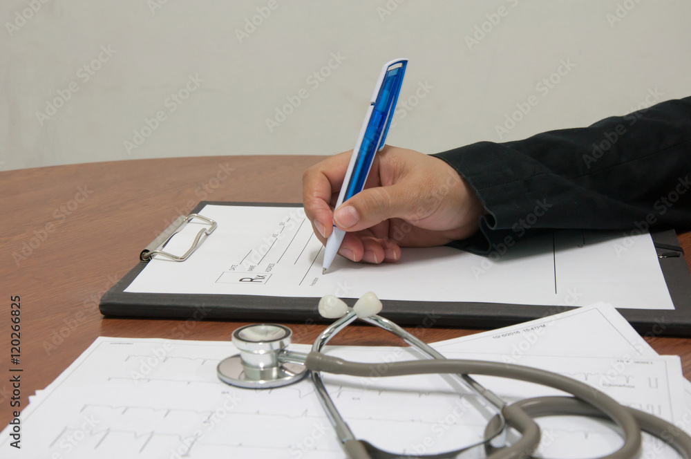 Doctor writing a medical prescription. Stock Photo | Adobe Stock