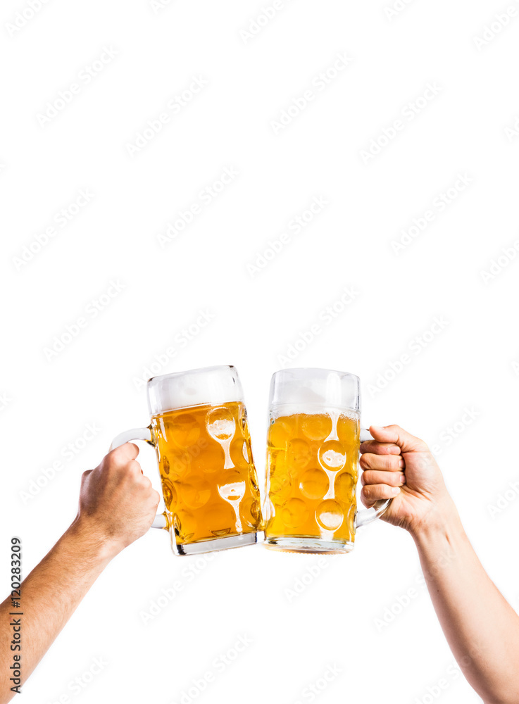 Two unrecognizable men clinking with beer mugs, studio shot Stock-Foto ...