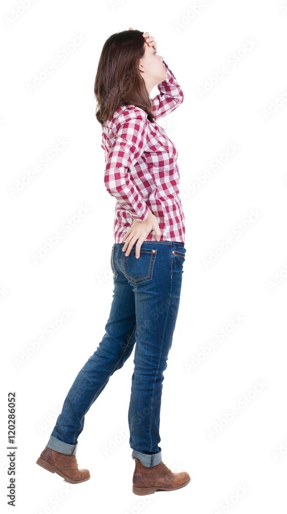 Back view of shocked woman in checkered shirt. girl hid his eyes behind ...