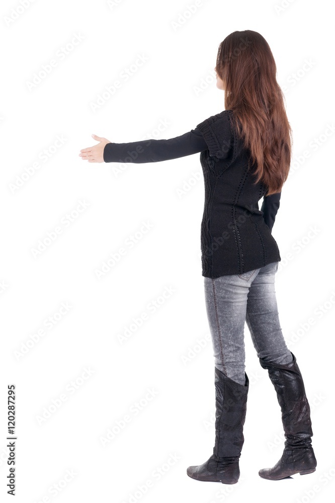 back view of businesswoman reaches out to shake hands. Rear view people ...