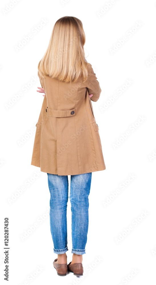 back view of standing young beautiful blonde woman in brown cloak. girl ...