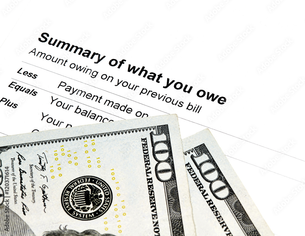 Foto Stock Summary of What you Owe Statement with US Currency | Adobe Stock