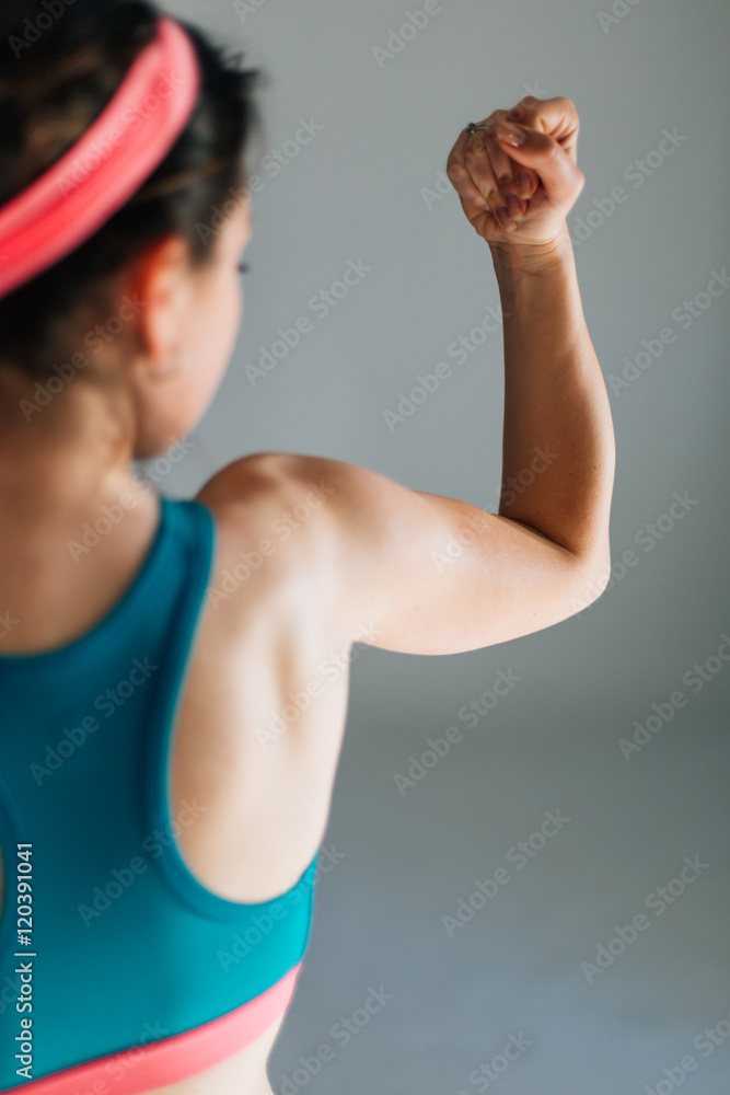 Woman flexing biceps Stock Photo | Adobe Stock