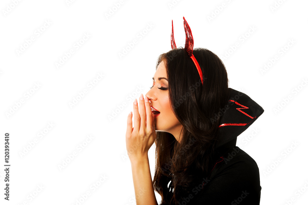 Woman in devil clothes whispering to someone foto de Stock | Adobe Stock