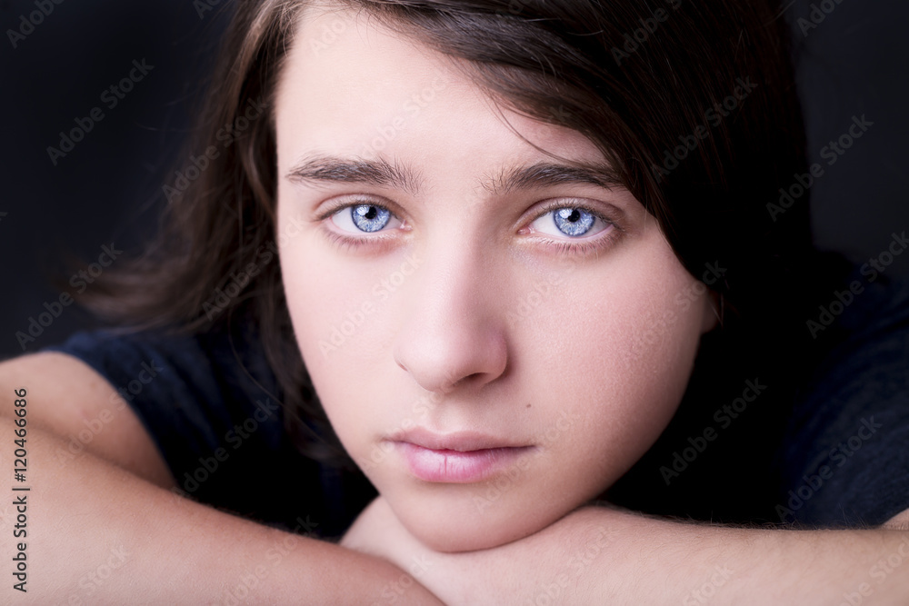 A portrait of a handsome blue eyes teenager on dark background Stock ...