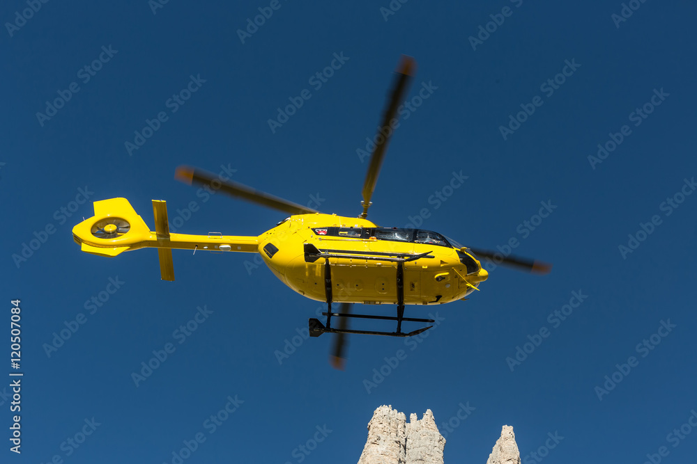 Medical rescue helicopter flying rescue injured climber on the Tre Cime ...