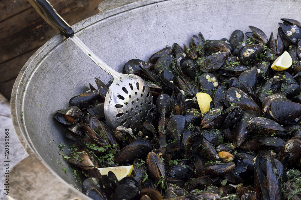 pot of cooked mussels with skimmer Stock Photo | Adobe Stock