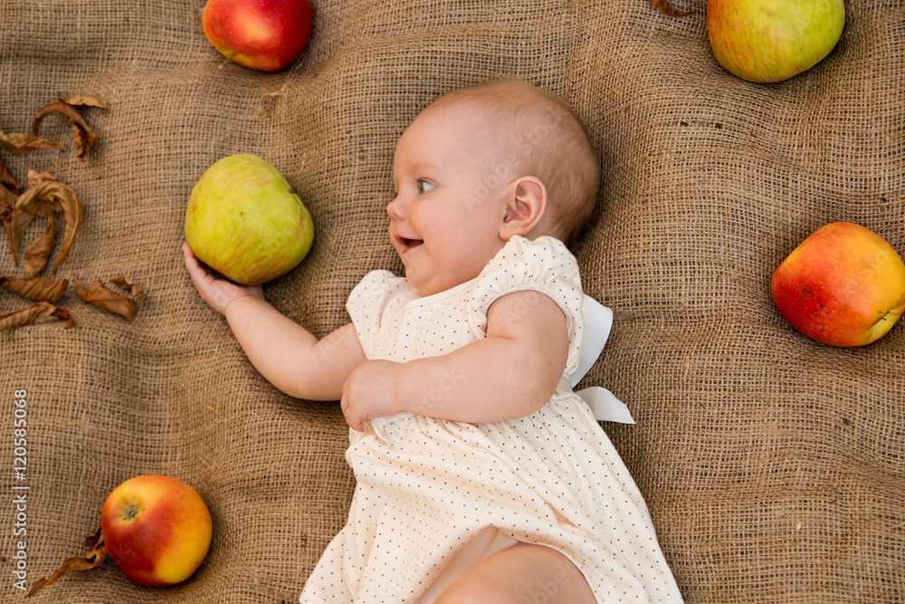 Cute baby girl with apples Stock Photo | Adobe Stock