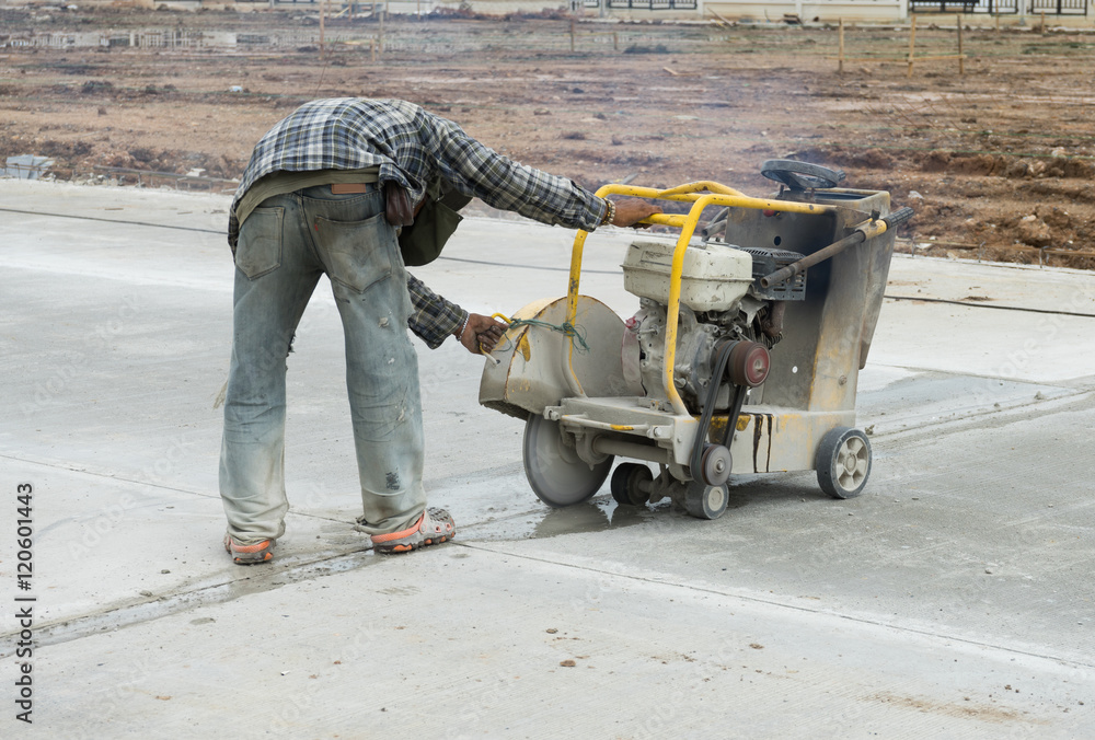 Labor construction worker using machine cutter joint concrete floor ...