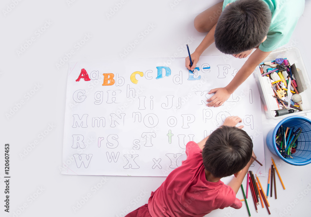 Little child boy painting and coloring alphabet in the paper indoor ...