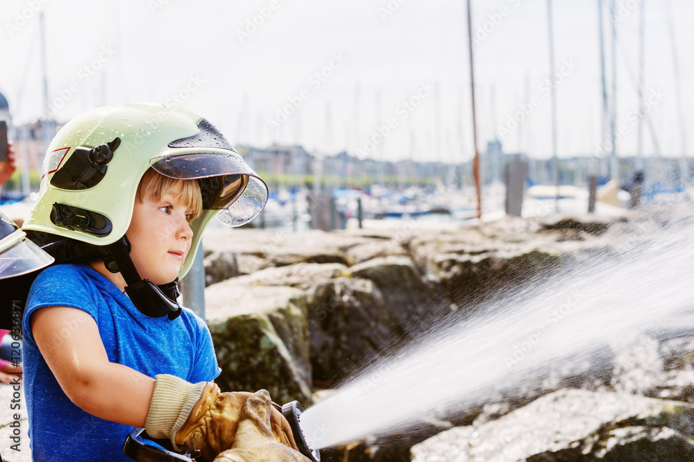 Little boy pretending to be firefighter, open doors day at fire station ...