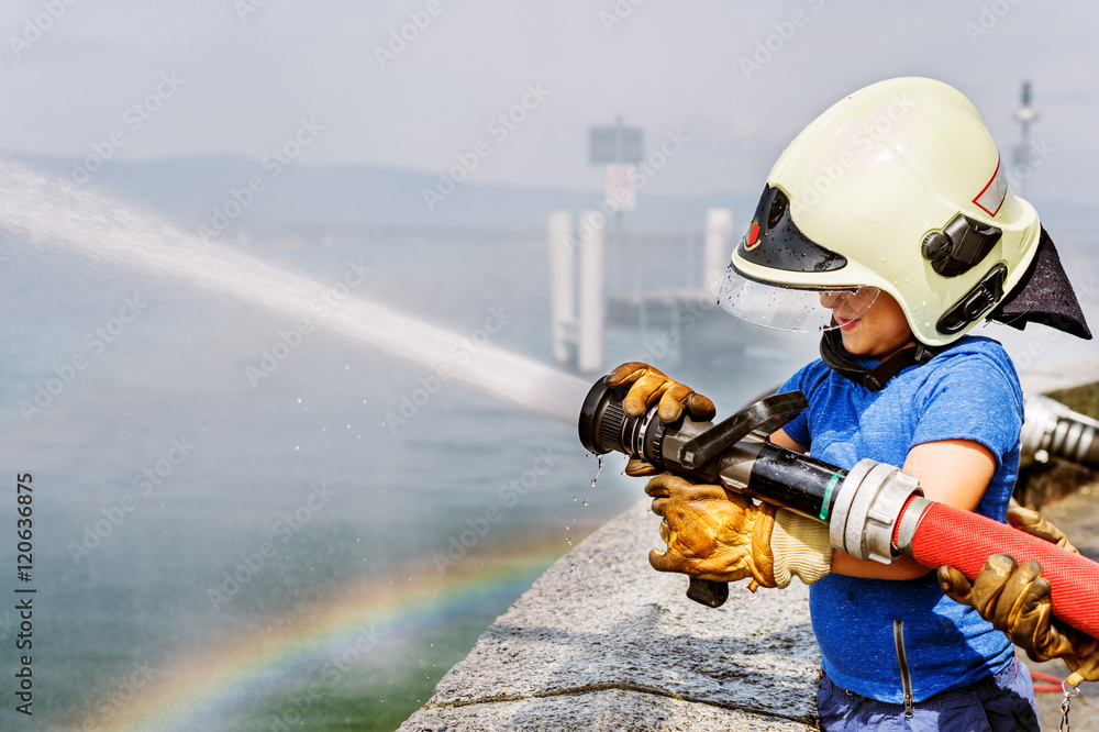 Little boy pretending to be firefighter, open doors day at fire station ...