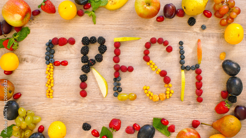 Word fresh on a wood background. Fruits on a table. Fruits made word ...