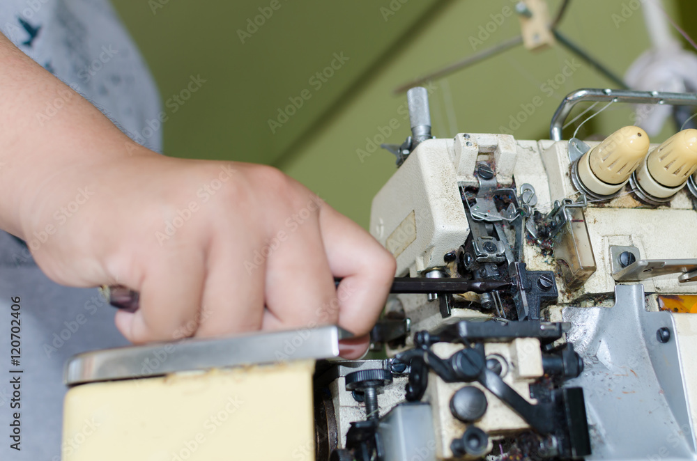 mechanic repairing industrial sewing machine Stock Photo | Adobe Stock