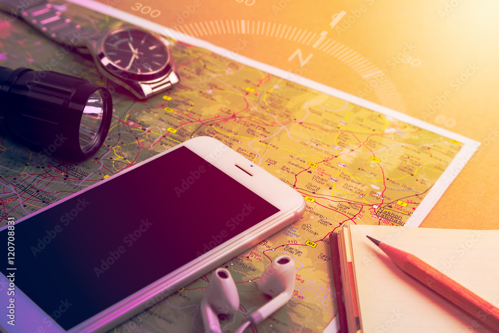 Travelling plan with smartphones, notebook, earphones, wrist watch and ...