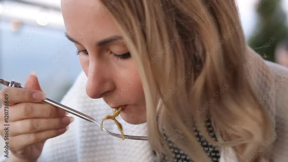 young woman eating spaghetti in cafe Stock Video | Adobe Stock