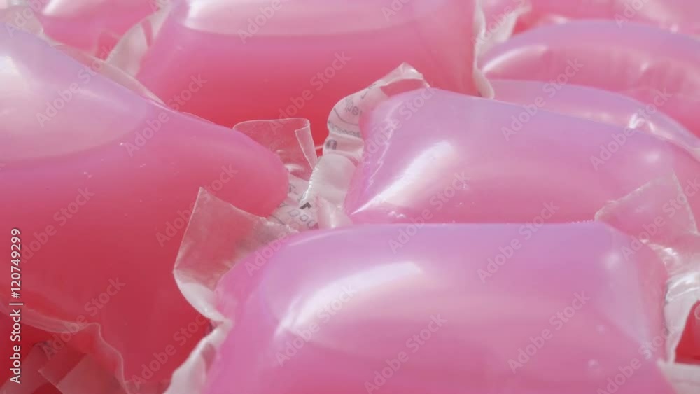 Pink laundry washing capsule pile modern pods close-up 4K 2160p 30fps ...