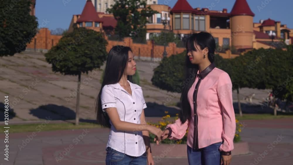 Two asian women meeting in the city. Adult female meet outdoors ...