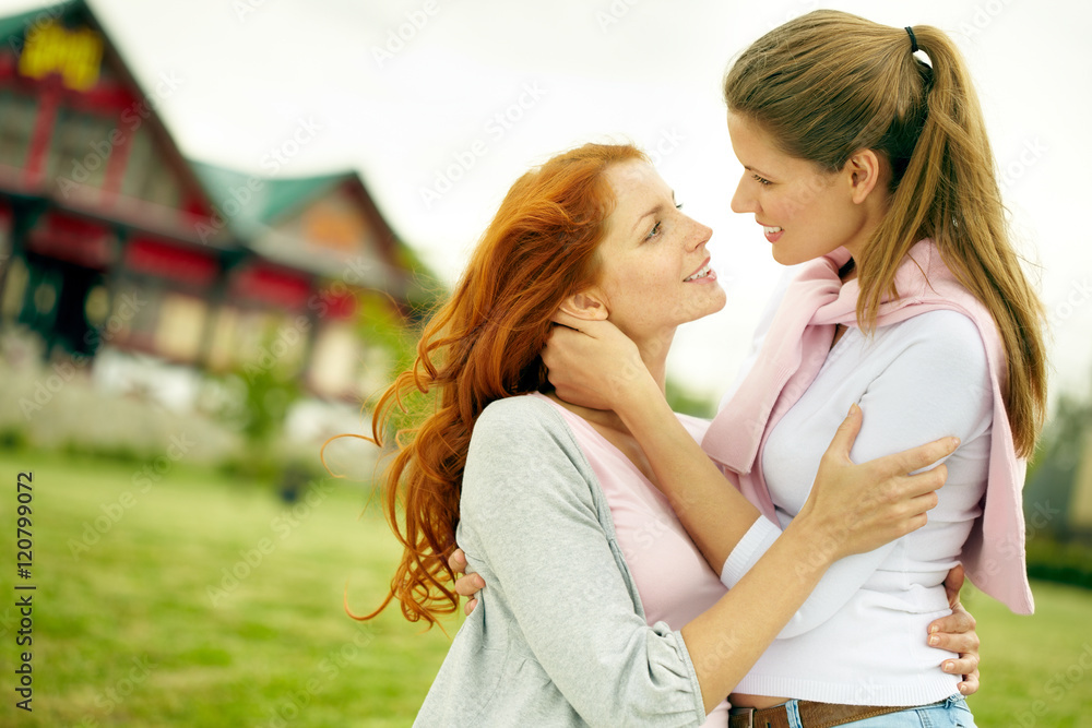 Portrait of two hugging girls looking tenderly at each other Stock ...