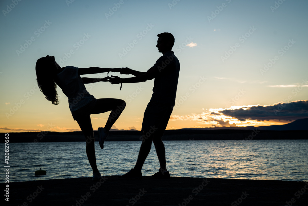 Couple dancing at sunset salsa / brazilian zouk. Lovers, dance partners ...