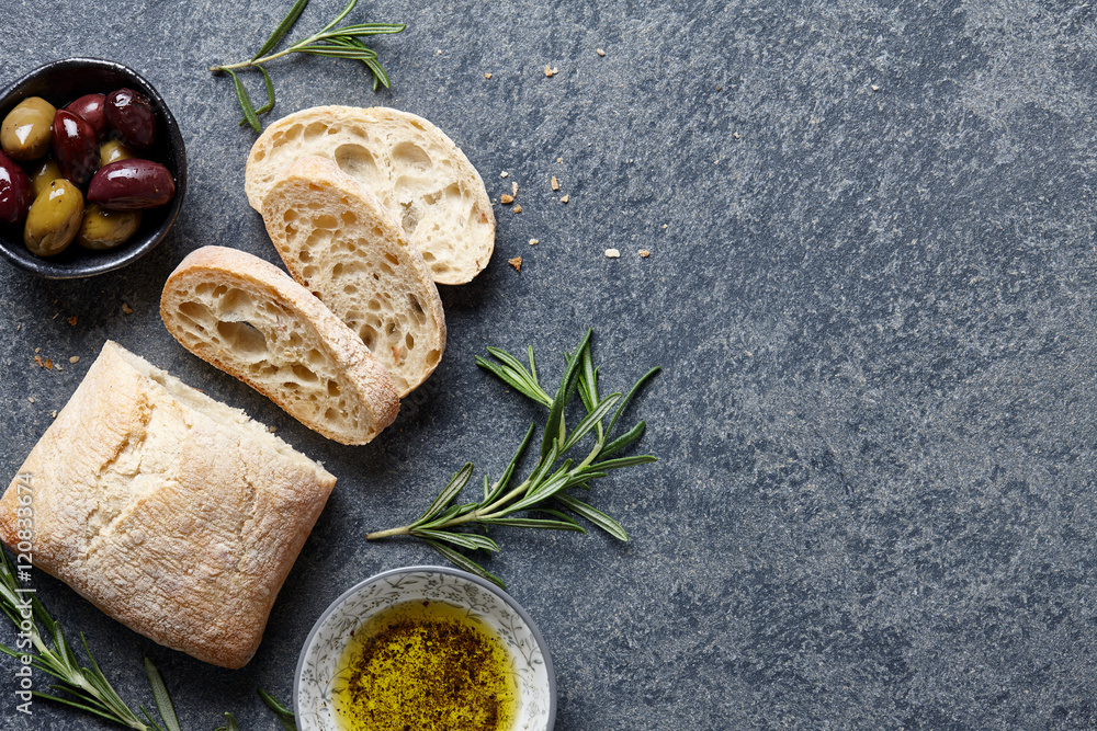 Italian food background with ciabatta bread, olive oil, olives and ...