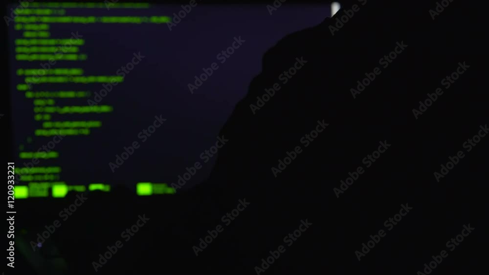 Professional hacker working at night, trying to break into system ...